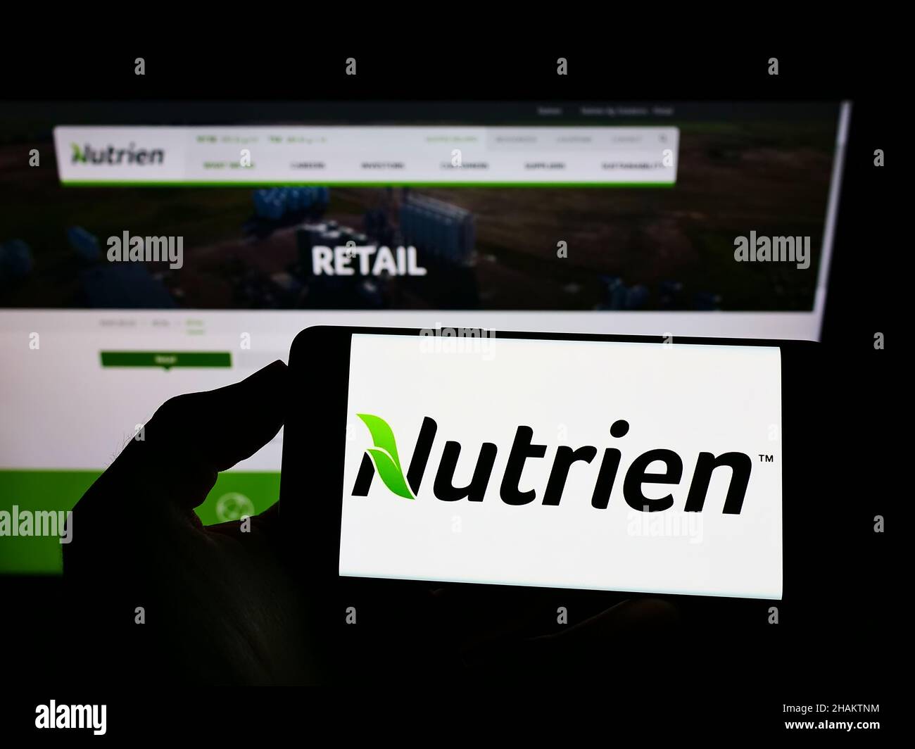 Person holding cellphone with logo of Canadian fertilizer company ...