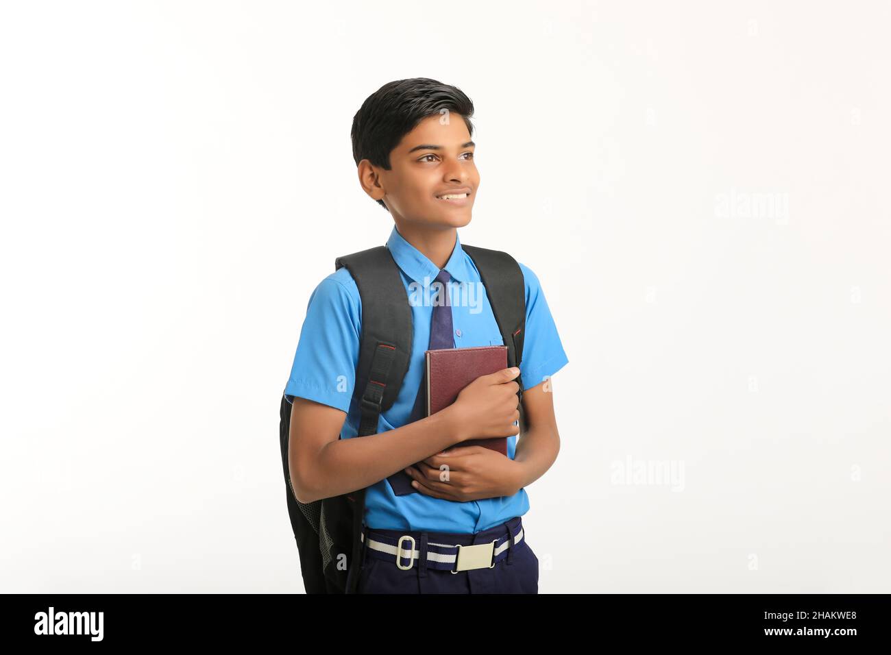 Indian school boy in uniform and holding diary in hand on white ...