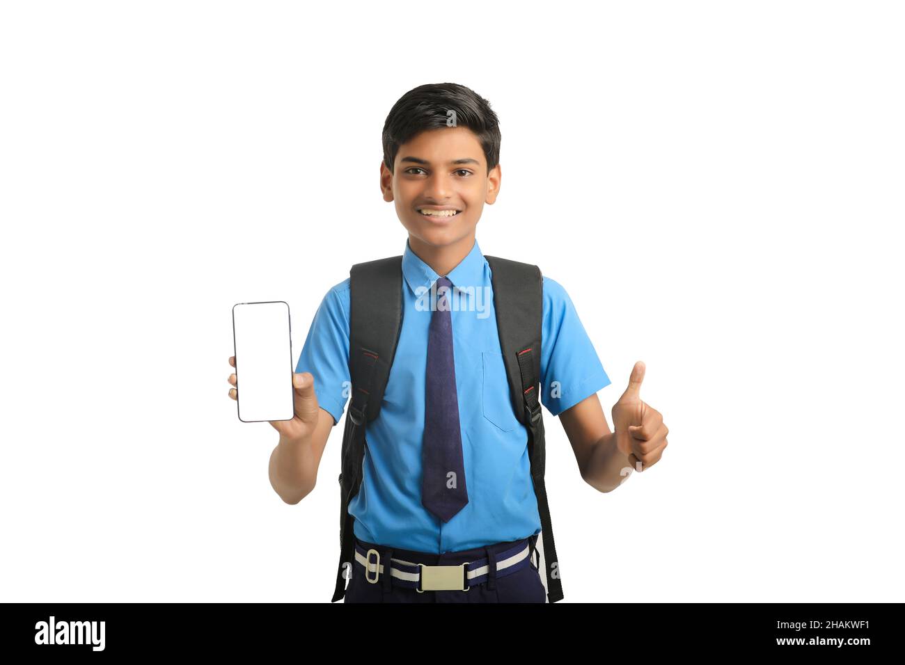 technology concept: Cute indian little school boy showing smartphone ...
