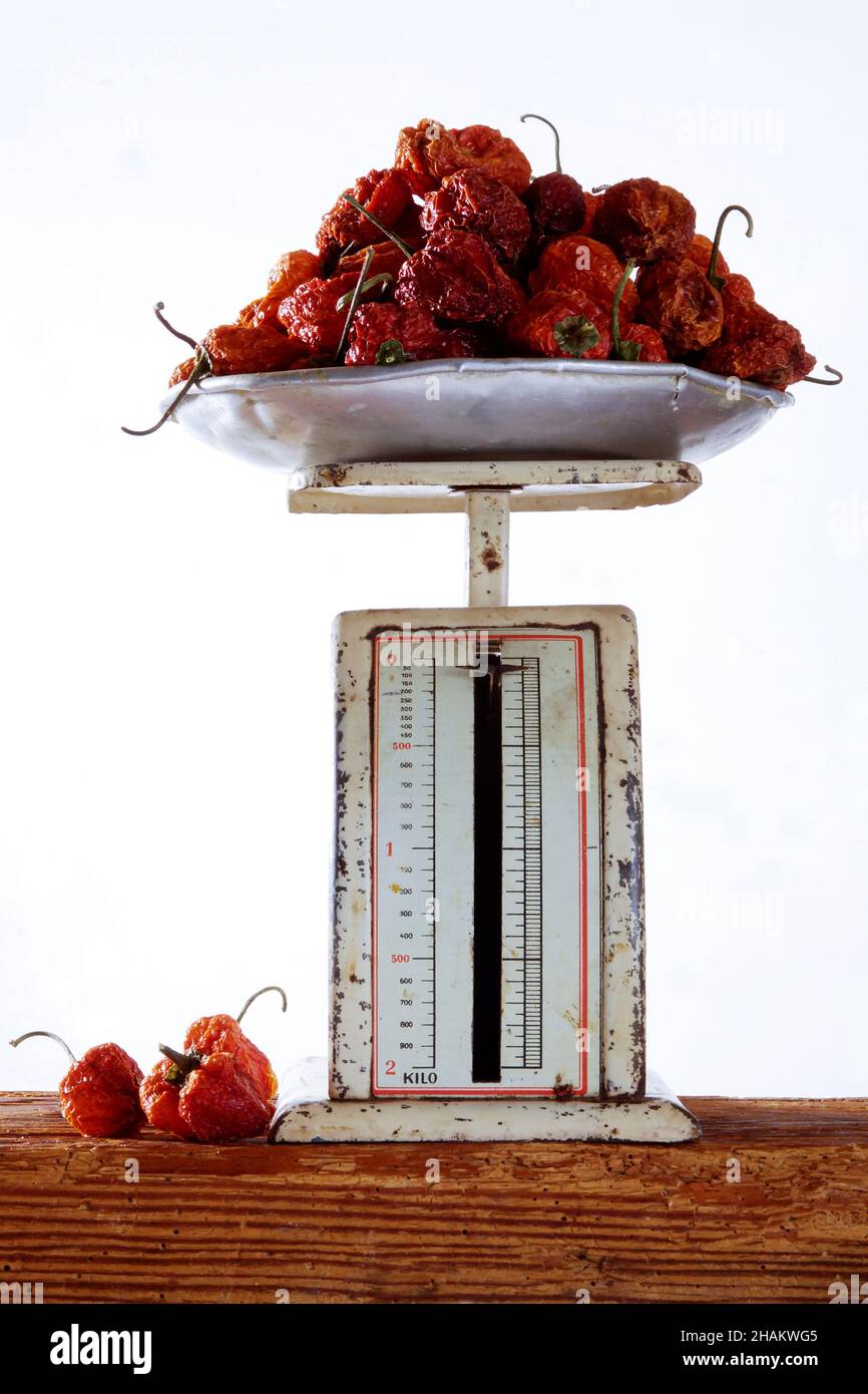 Paprika on old metal scales on wooden beams, isolated Stock Photo - Alamy