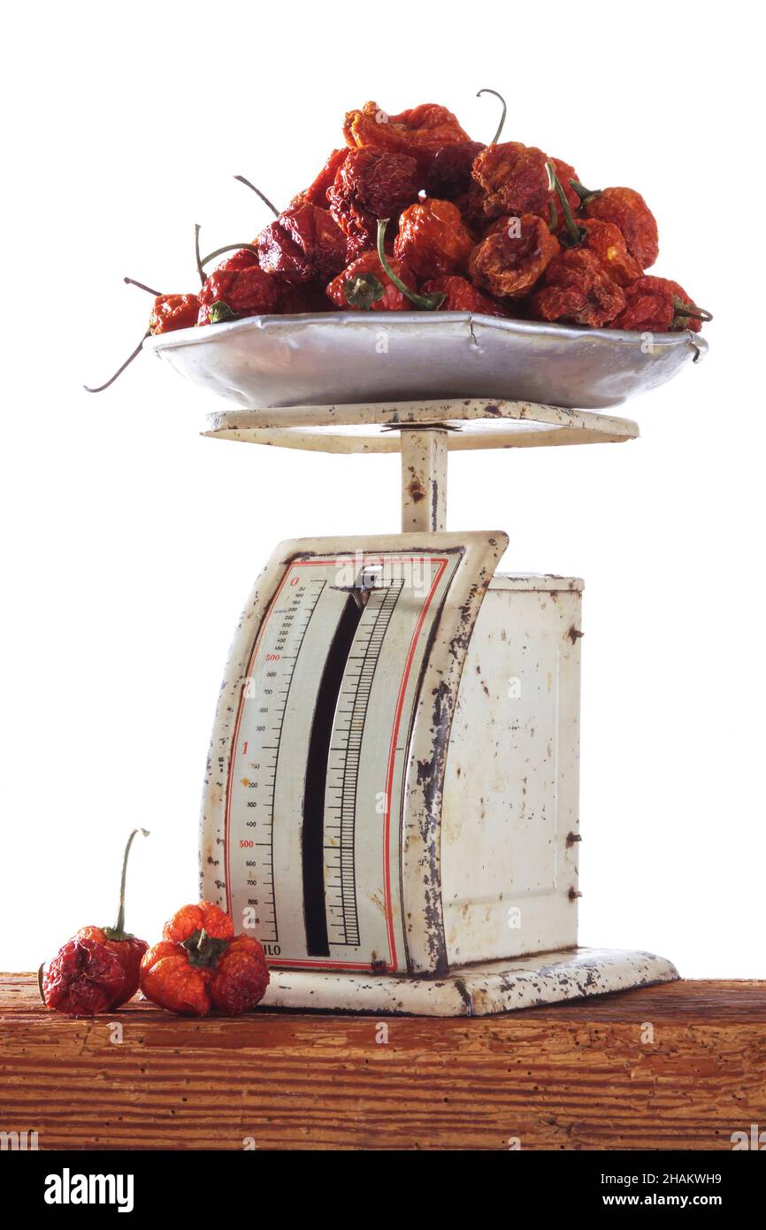 Paprika on old metal scales on wooden beams, isolated Stock Photo - Alamy