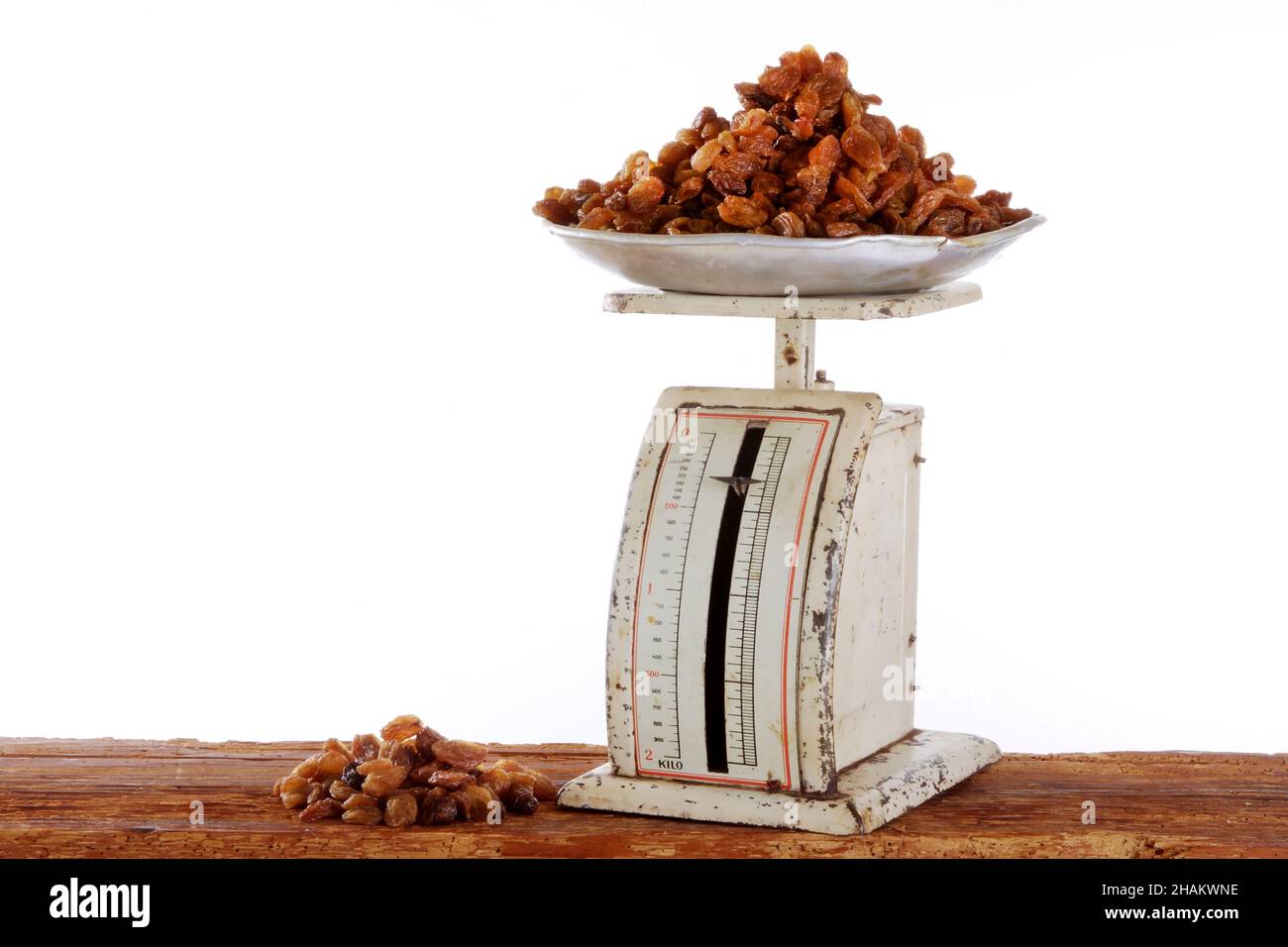 raisins on old metal scales on wooden beams, isolated Stock Photo - Alamy