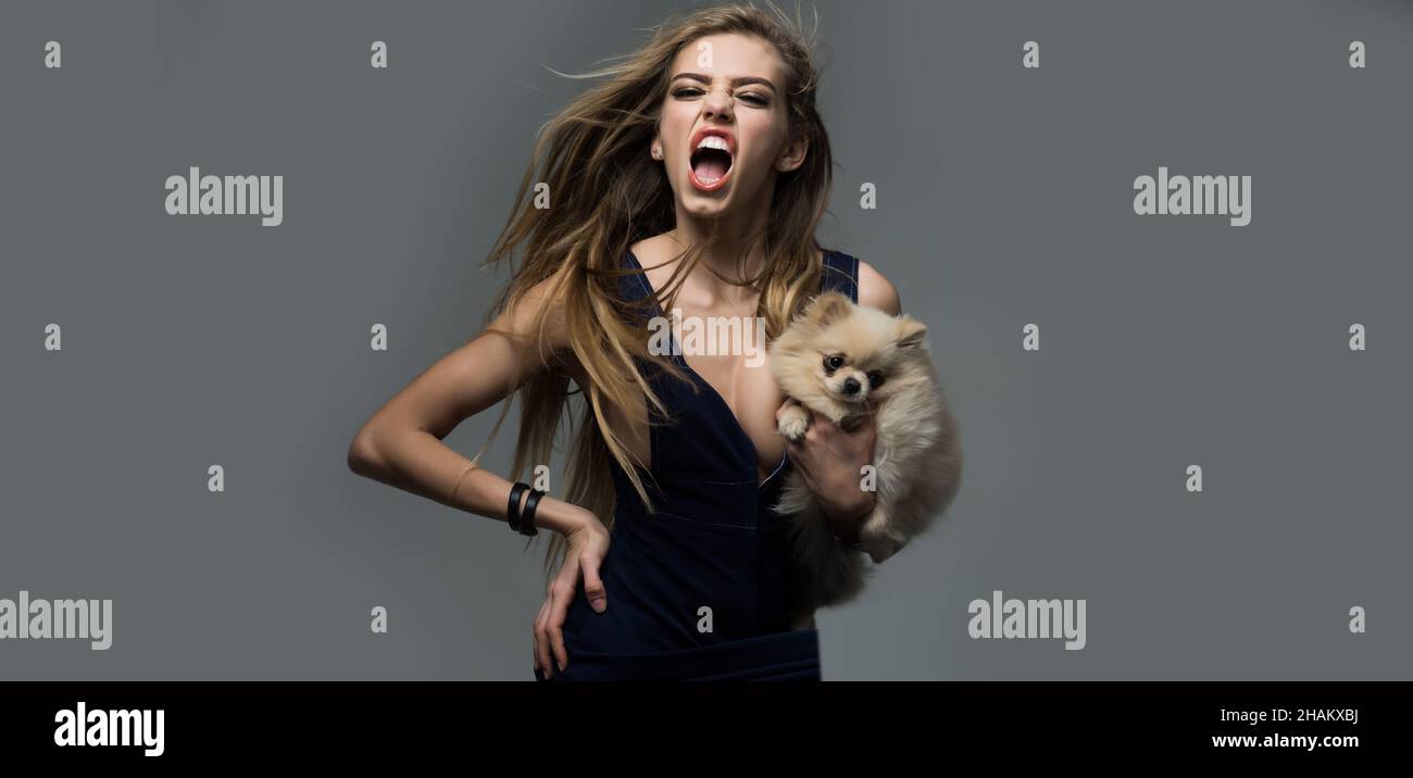 Young woman with pet dog screaming and shouting. Human emotions, facial ...
