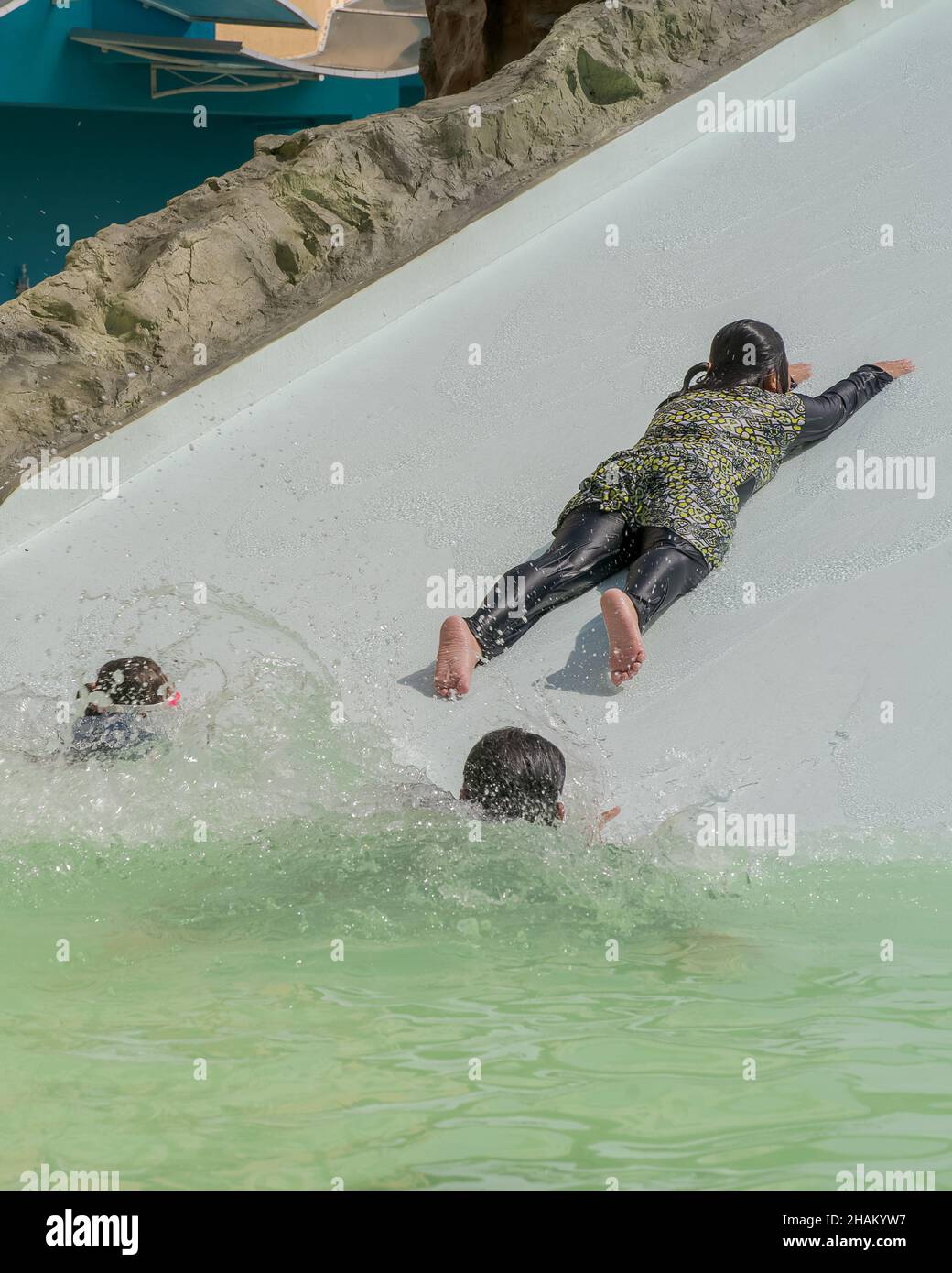 Happy boy going down slide hi-res stock photography and images - Alamy