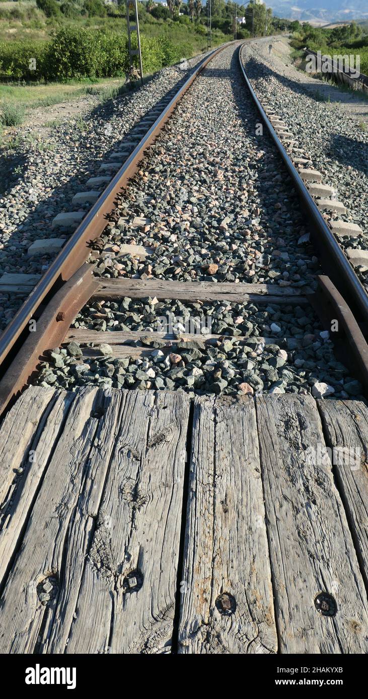 Railway crossing in rural cut with wooden sleepers near Alora ...