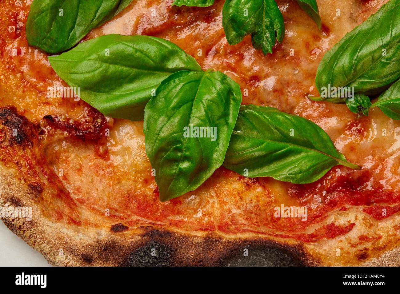 Closeup of pizza Margherita with cheesea, tomatoes and basil leaves ...