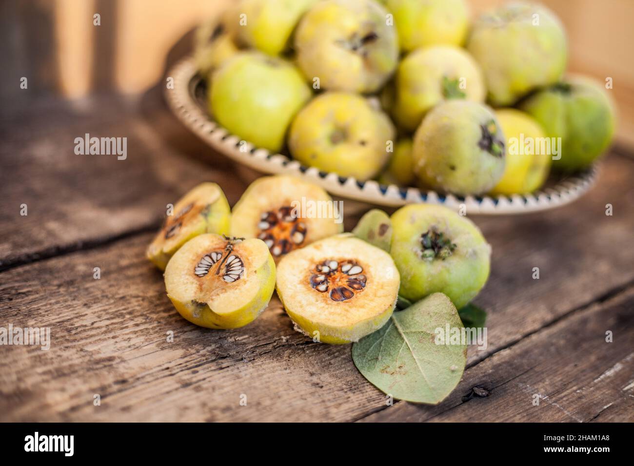 Quince fruits on a wooden background. Harvest of autumn fruits. Yellow ...