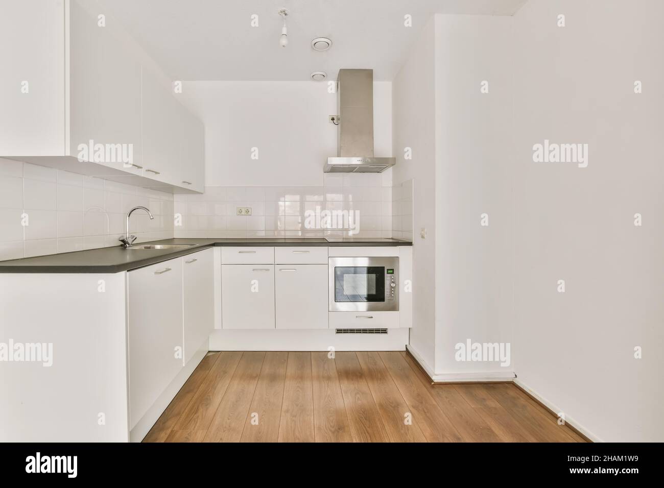 Luxurious small kitchen with white kitchen unit and delightful parquet ...