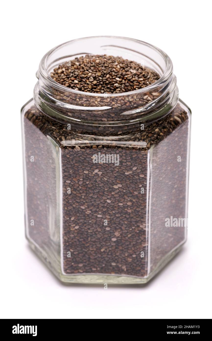 glass can full of organic natural chia seeds close-up isolated on white ...