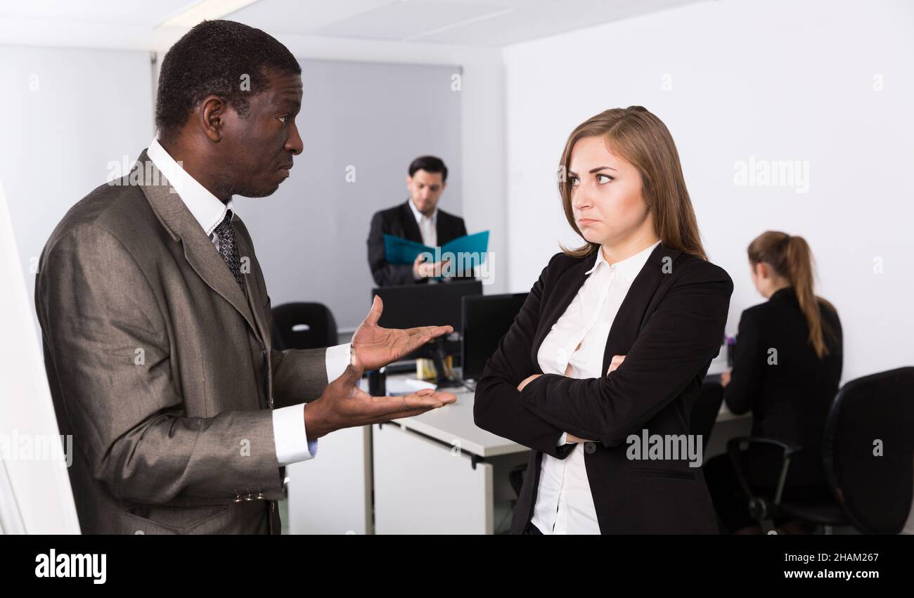 Unhappy woman manager listening angry man boss Stock Photo - Alamy