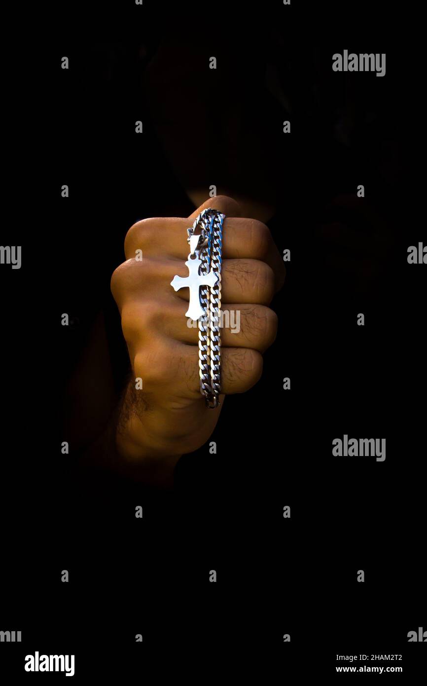 Hand holding cross necklace outdoor hi-res stock photography and images ...