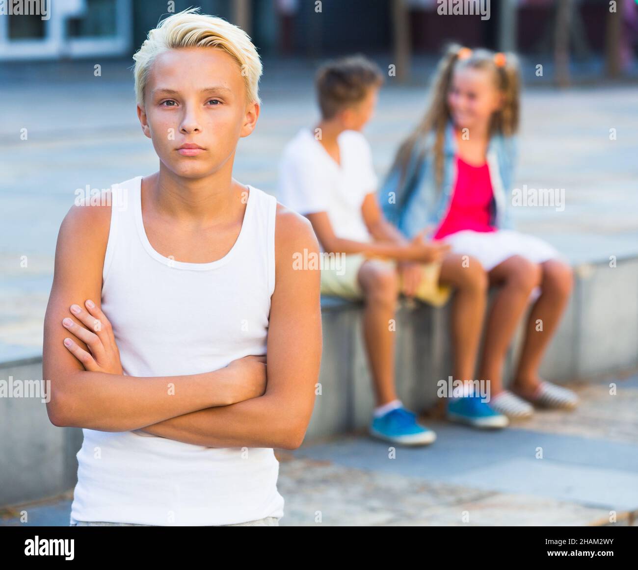 Sad boy having problems with friends Stock Photo - Alamy