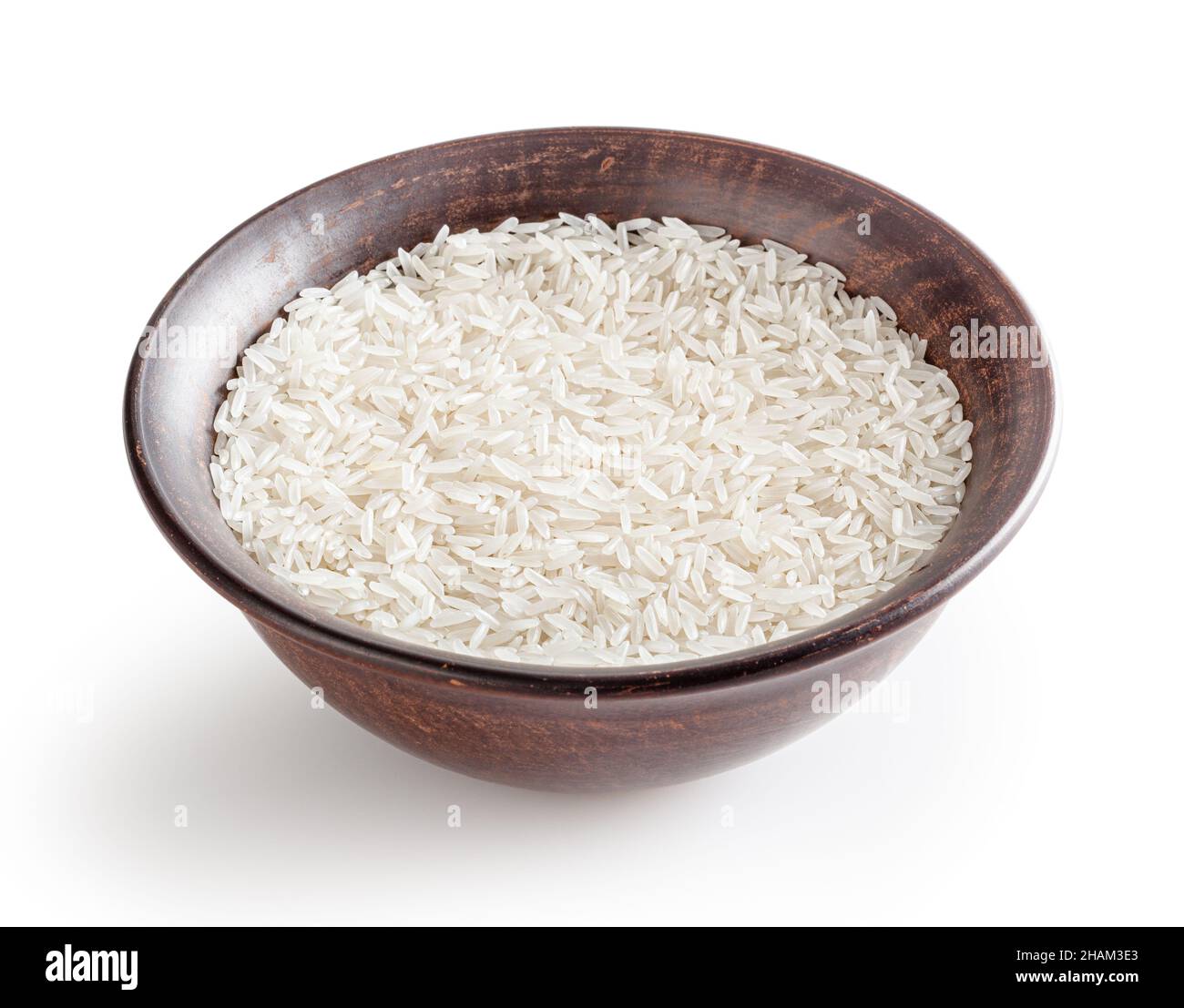Uncooked jasmine rice in ceramic bowl isolated on white background with ...