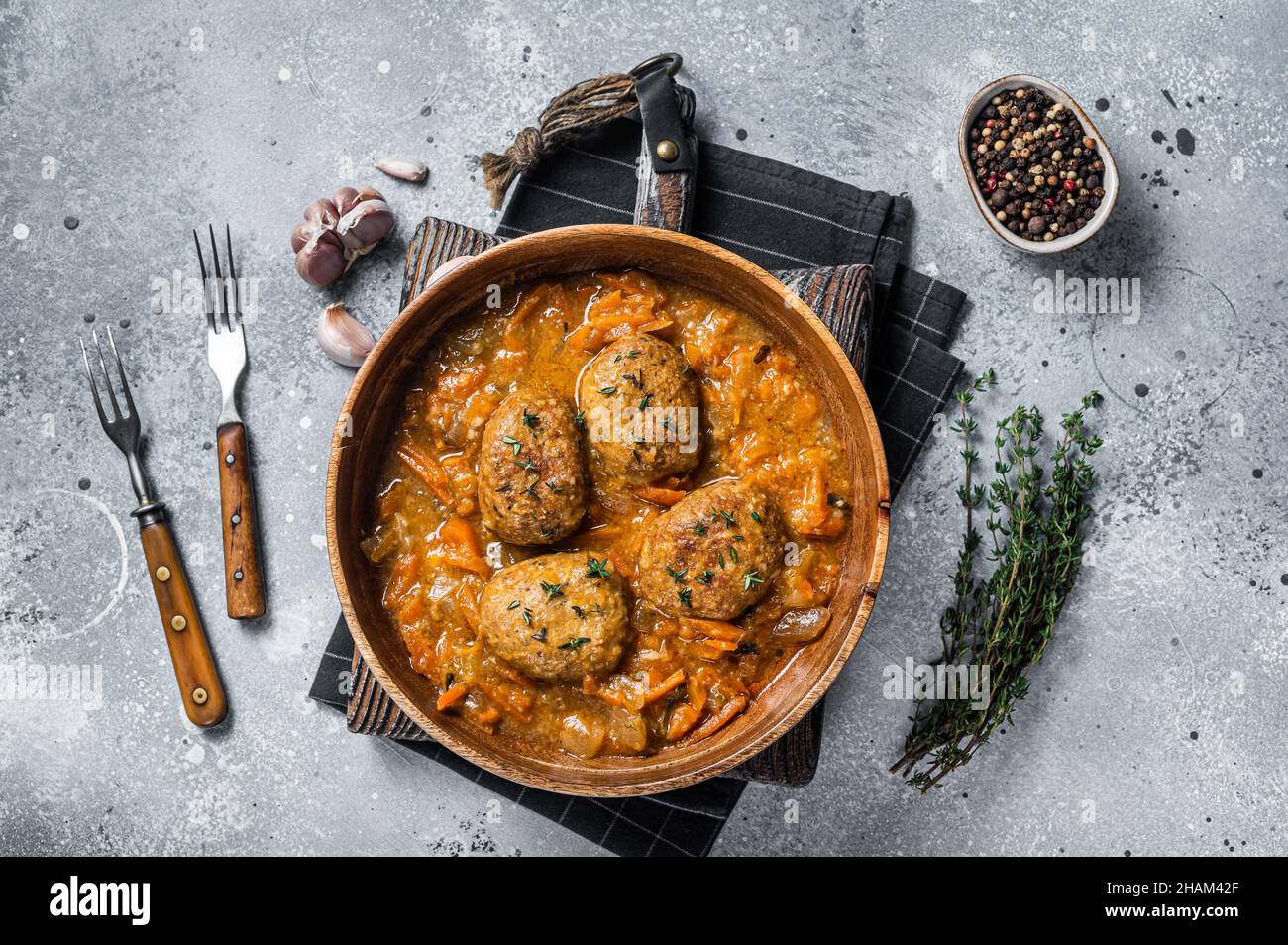 Cutlets or Fish balls with tuna in tomato sauce. Gray background. Top ...