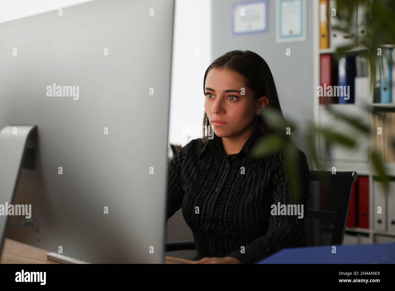 Young office worker stare at computer screen, search information online ...