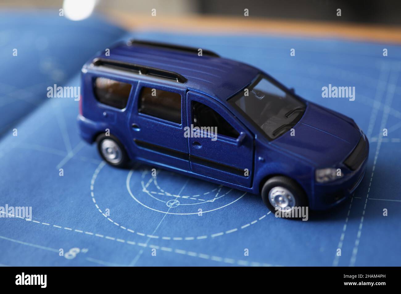 New car model development, miniature automobile model on blueprint ...