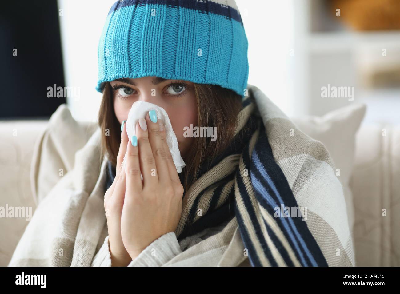 Sick person blowing running nose and sneezing in tissue stay at home on ...