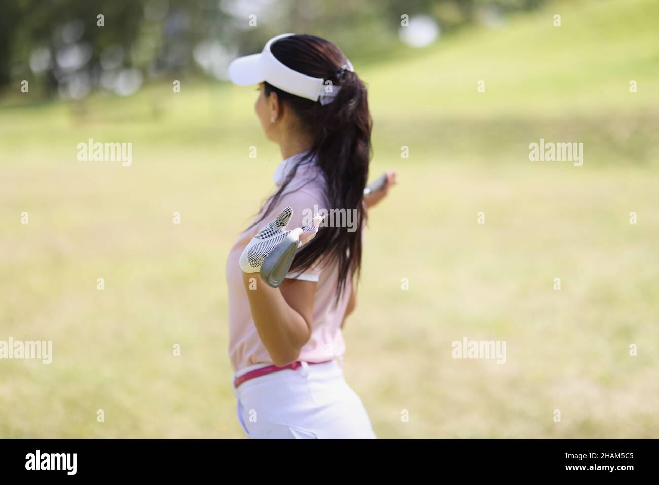 Professional woman golf player pose with golf club on field Stock Photo ...