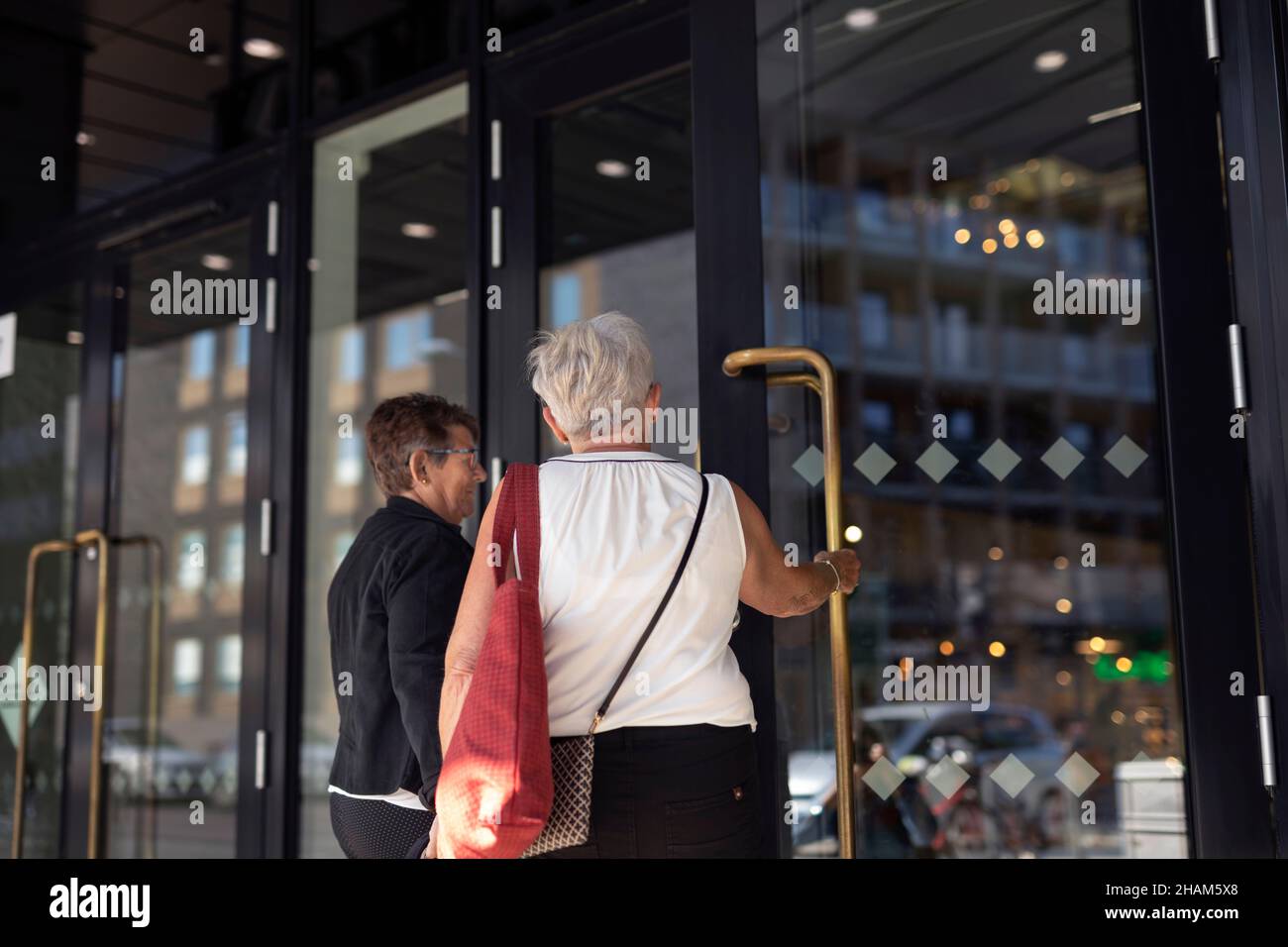 Women entering hi-res stock photography and images - Alamy