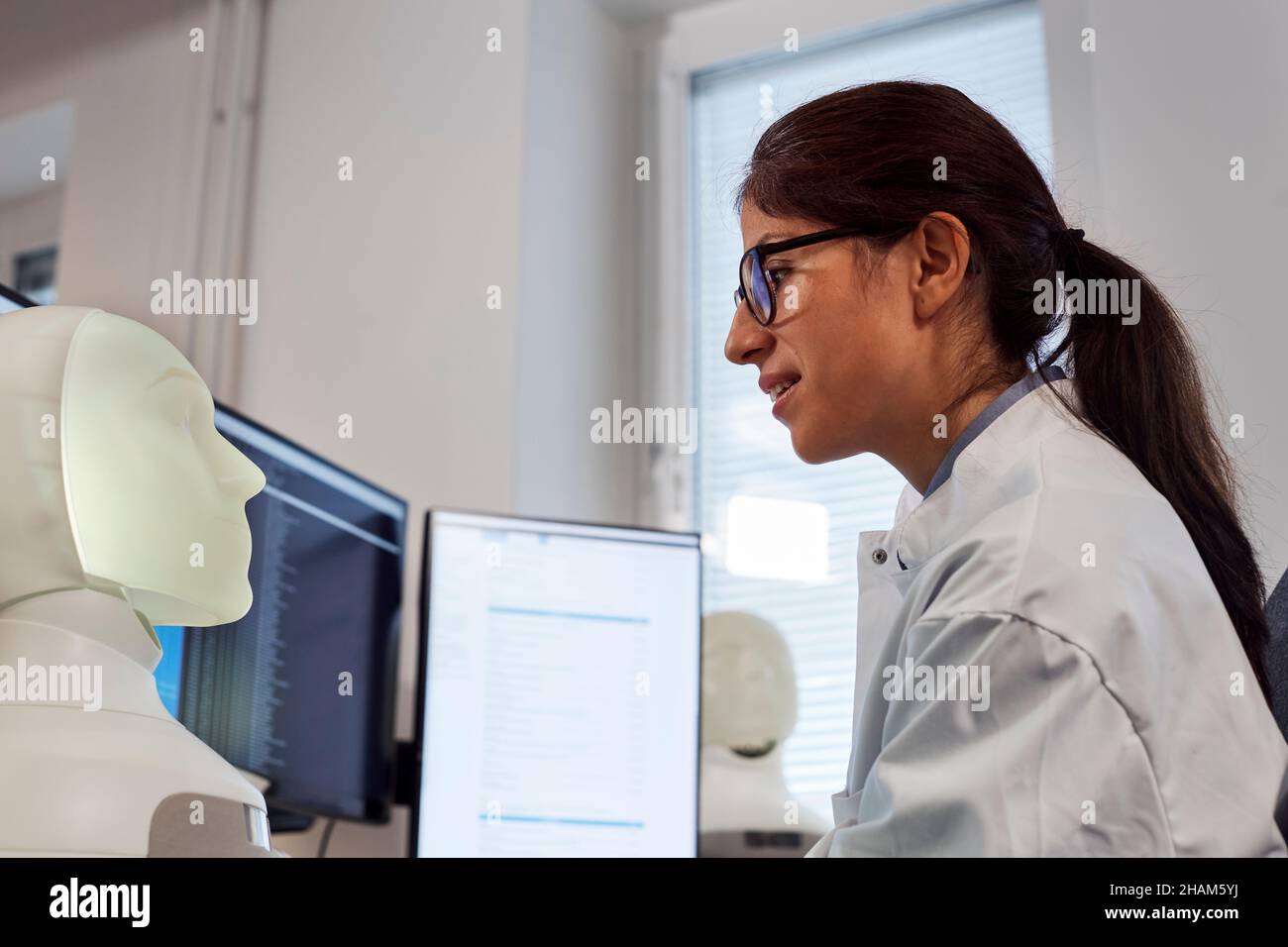 Female engineer working on robot Stock Photo - Alamy