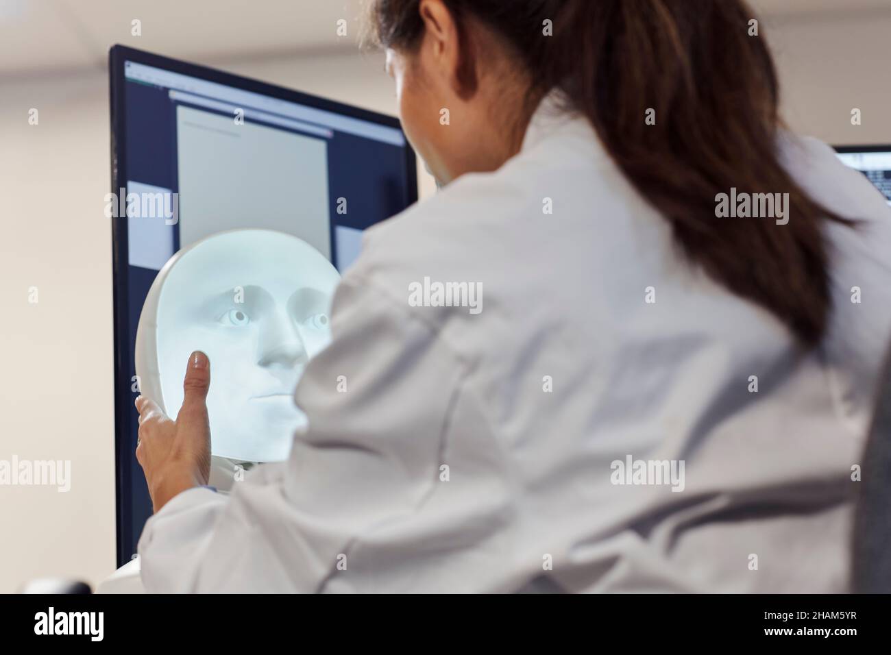 Female engineer building robot with human face Stock Photo - Alamy