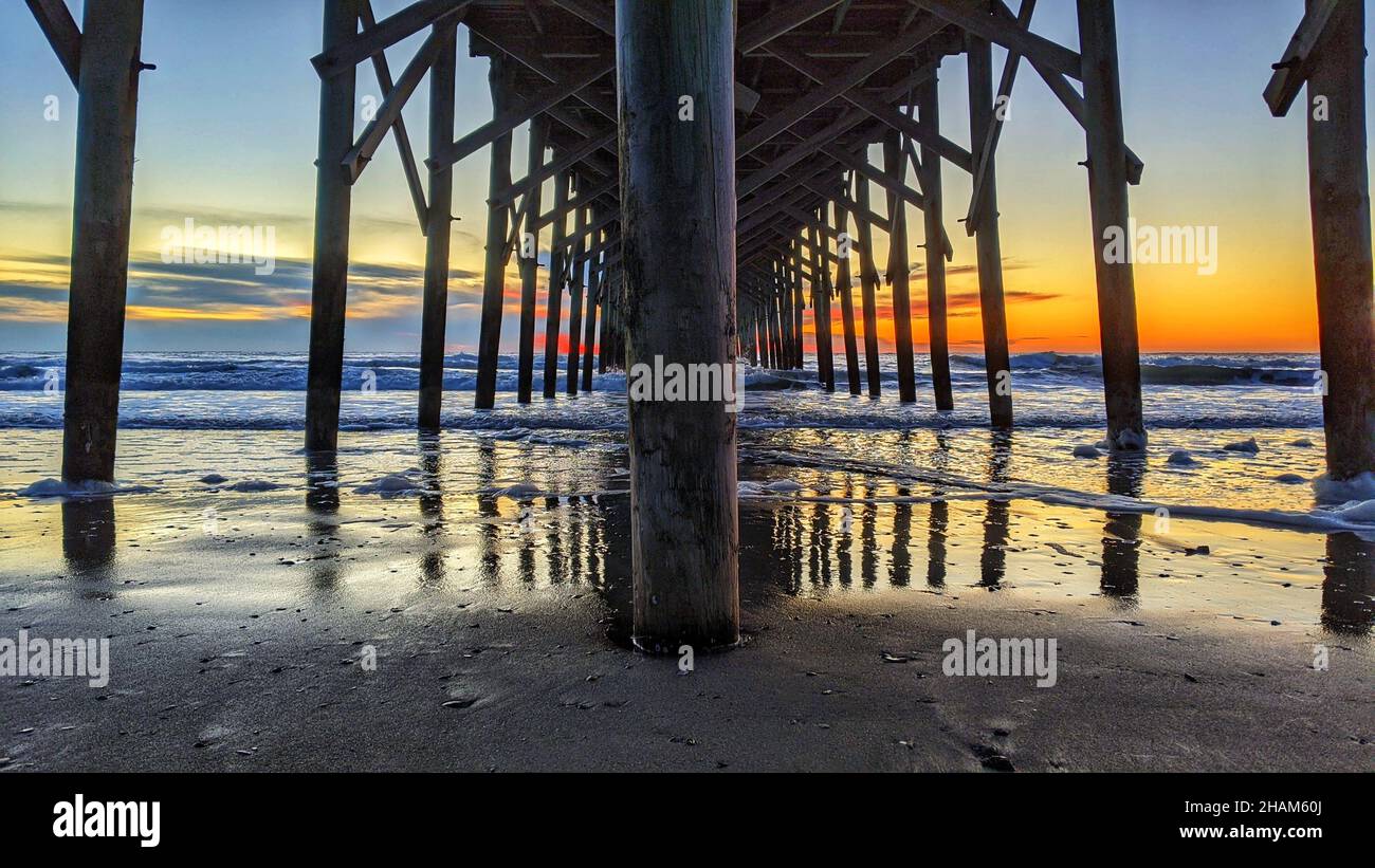 Beautiful scenery under the boardwalk in the seashore with a sunset ...