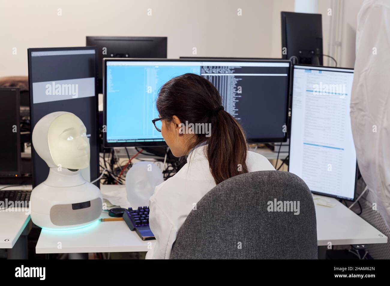 Female engineer working on robot Stock Photo - Alamy
