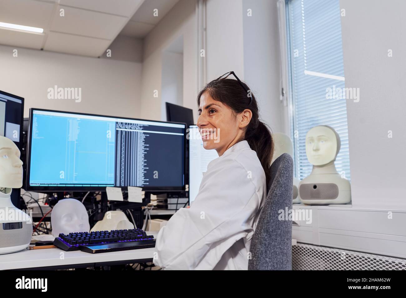 Female engineer sitting at work station Stock Photo - Alamy