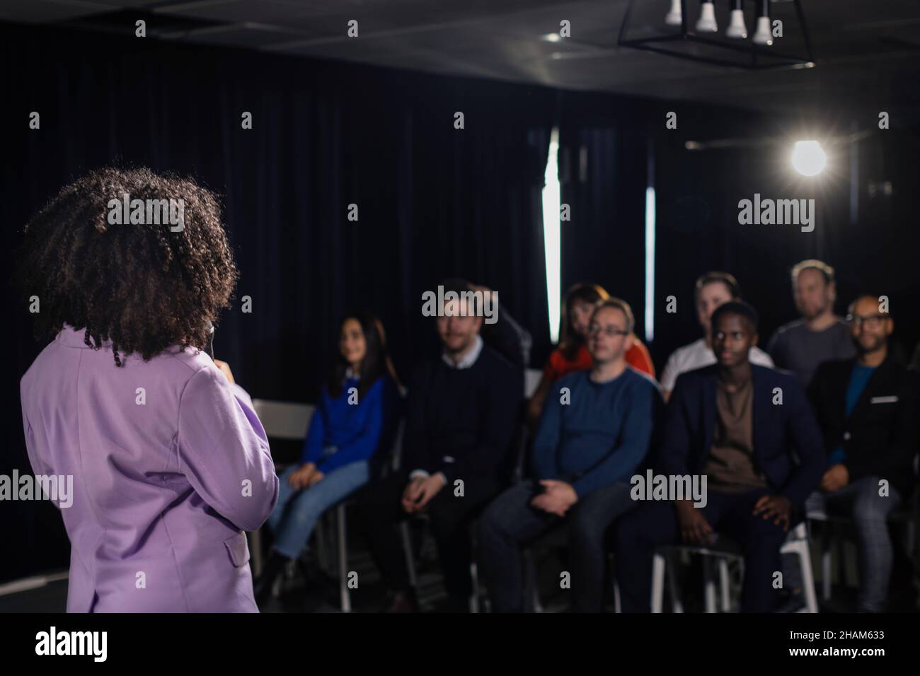 TV show host standing in front of audience Stock Photo - Alamy