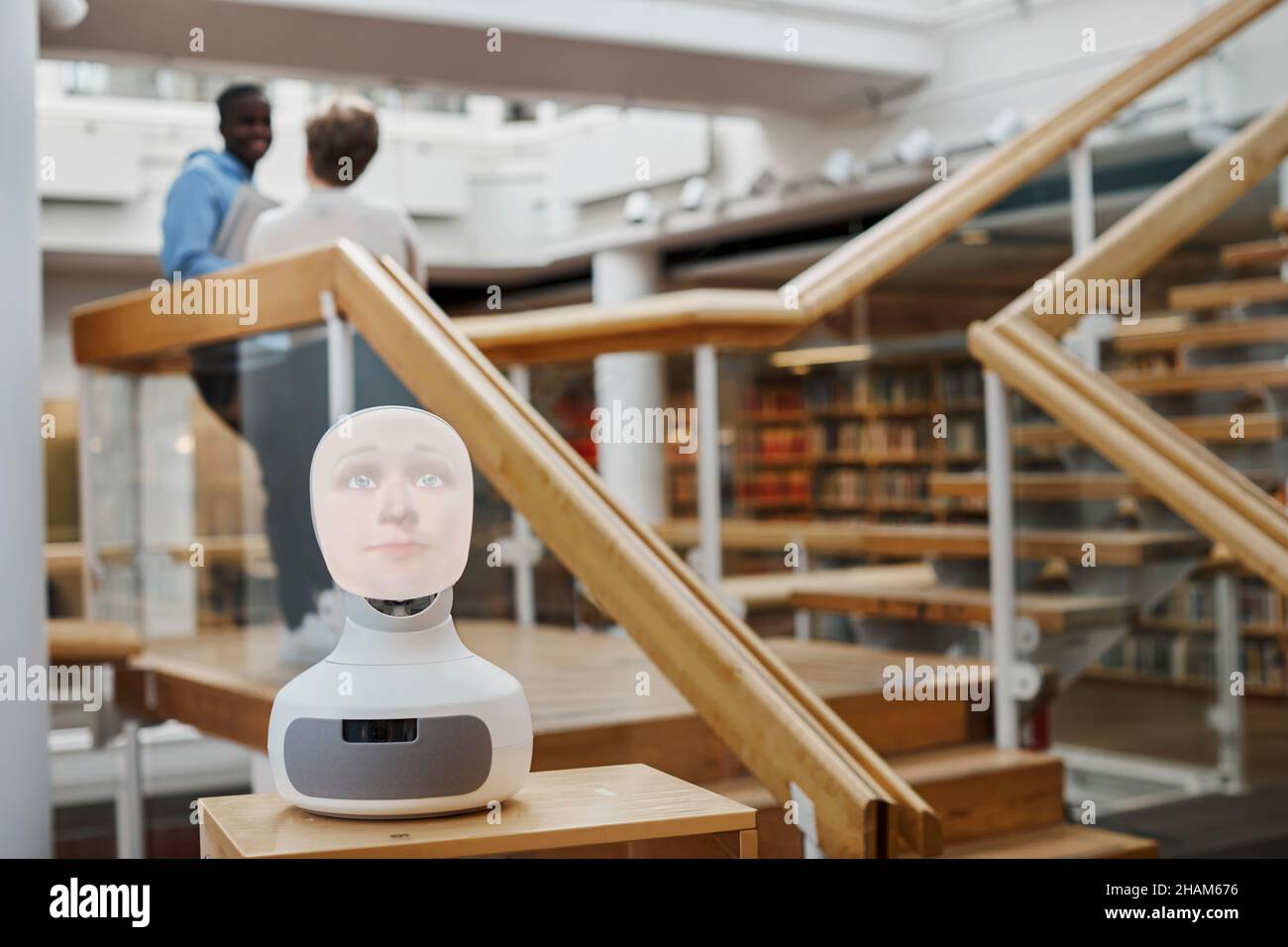 Voice assistant with human face in library Stock Photo - Alamy