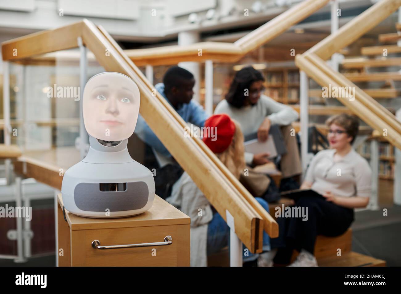 Voice assistant with human face in library Stock Photo - Alamy
