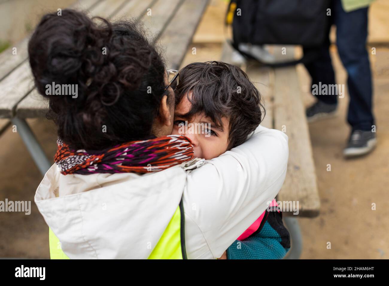 Preschool teacher hugging crying student Stock Photo - Alamy