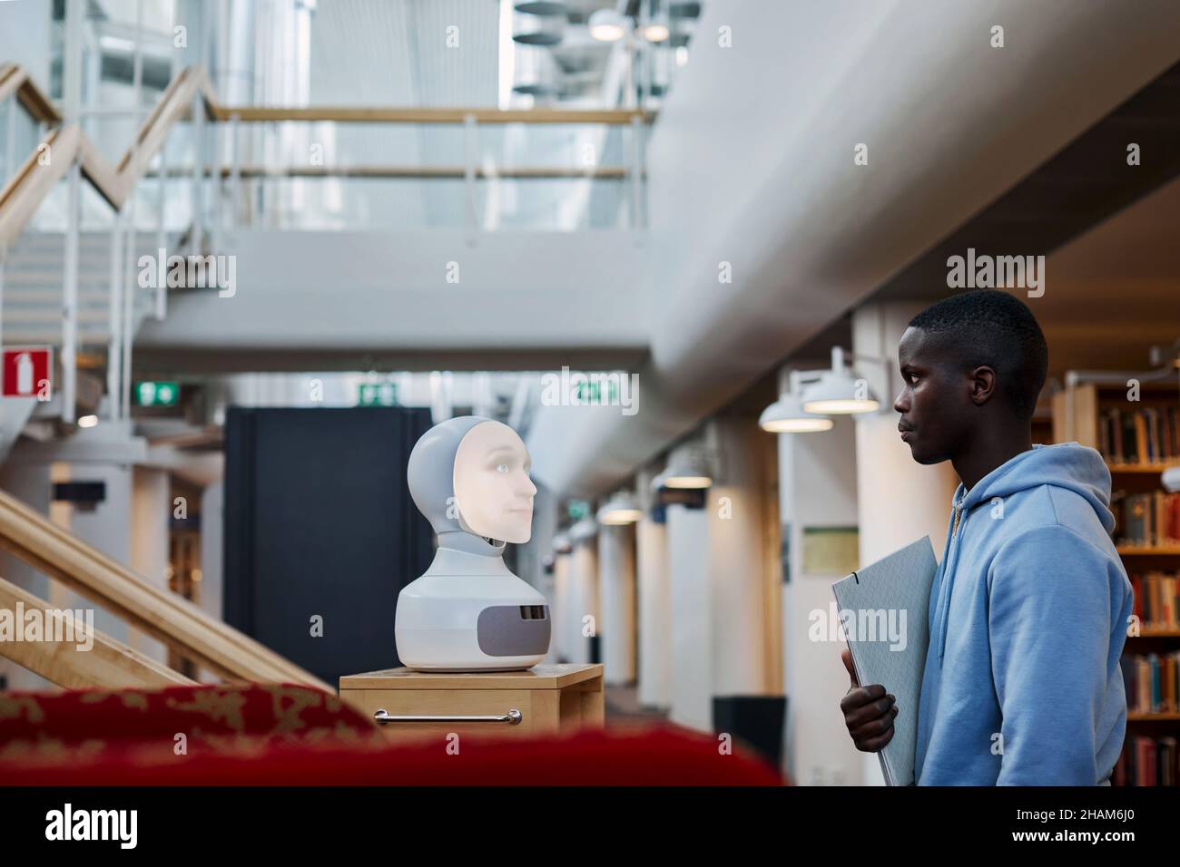 Student using voice assistant in library Stock Photo - Alamy