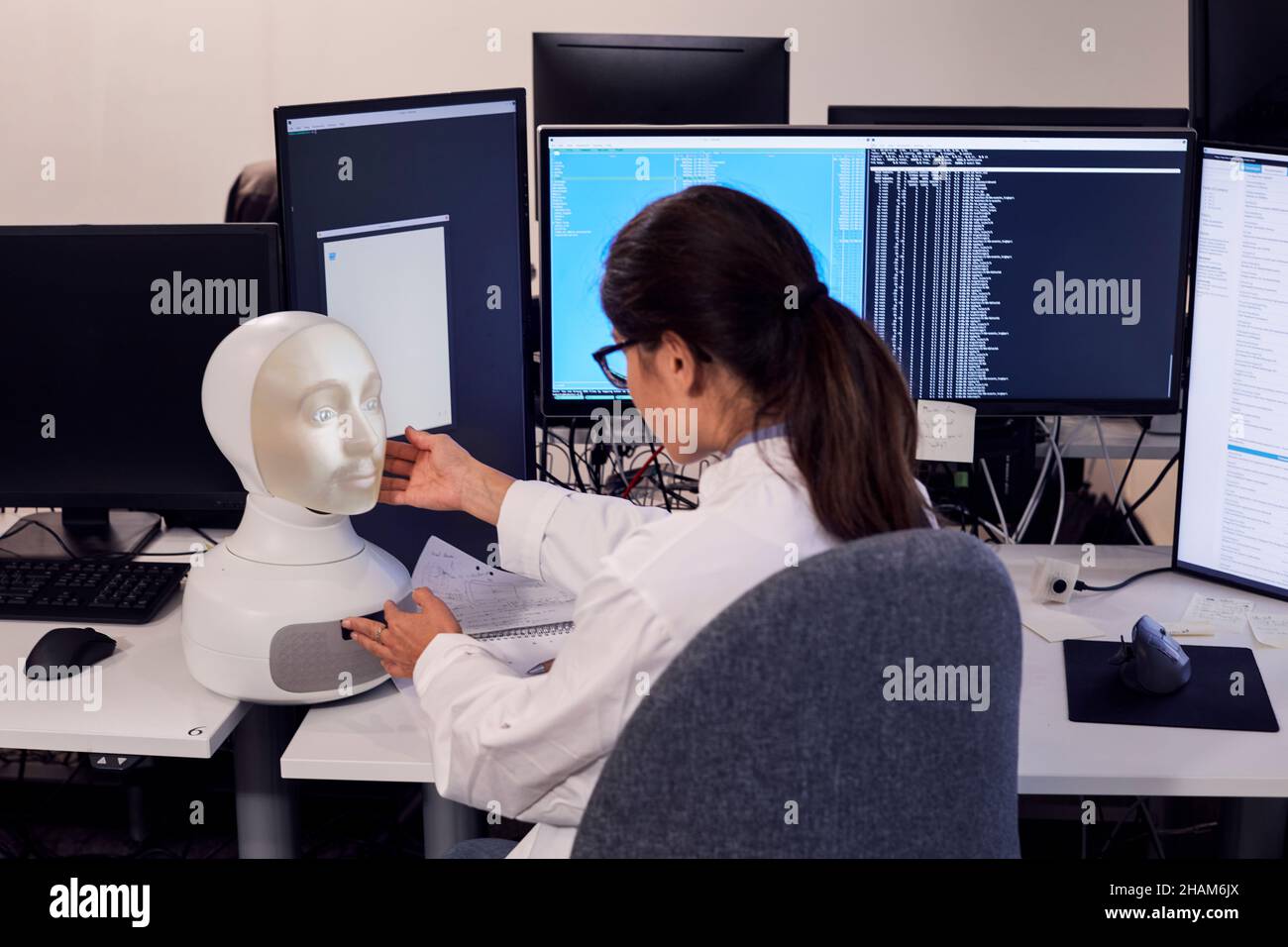 Female engineer building robot with human face Stock Photo - Alamy