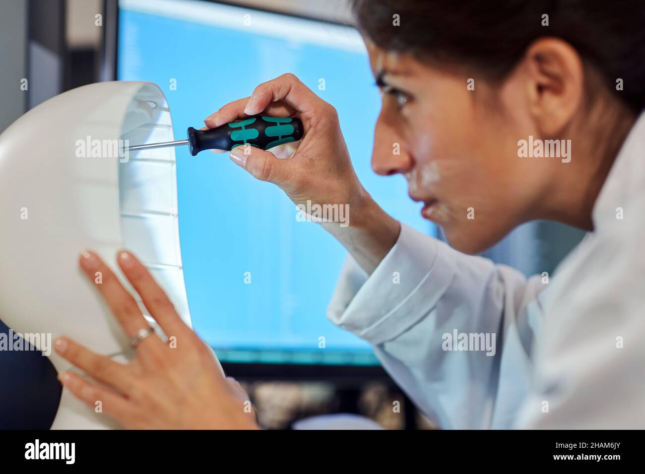 Female engineer building robot with screwdriver Stock Photo - Alamy