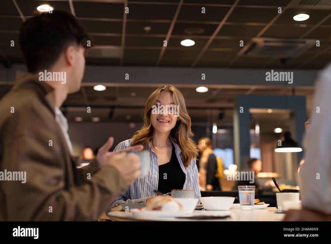 People talking during lunch in cafe Stock Photo - Alamy