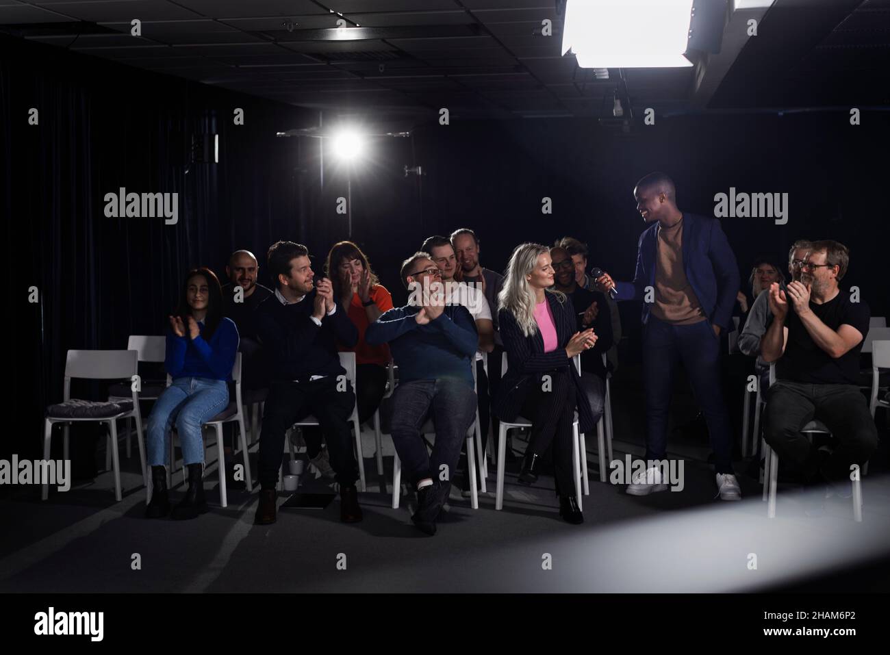 TV show host interviewing audience member Stock Photo - Alamy