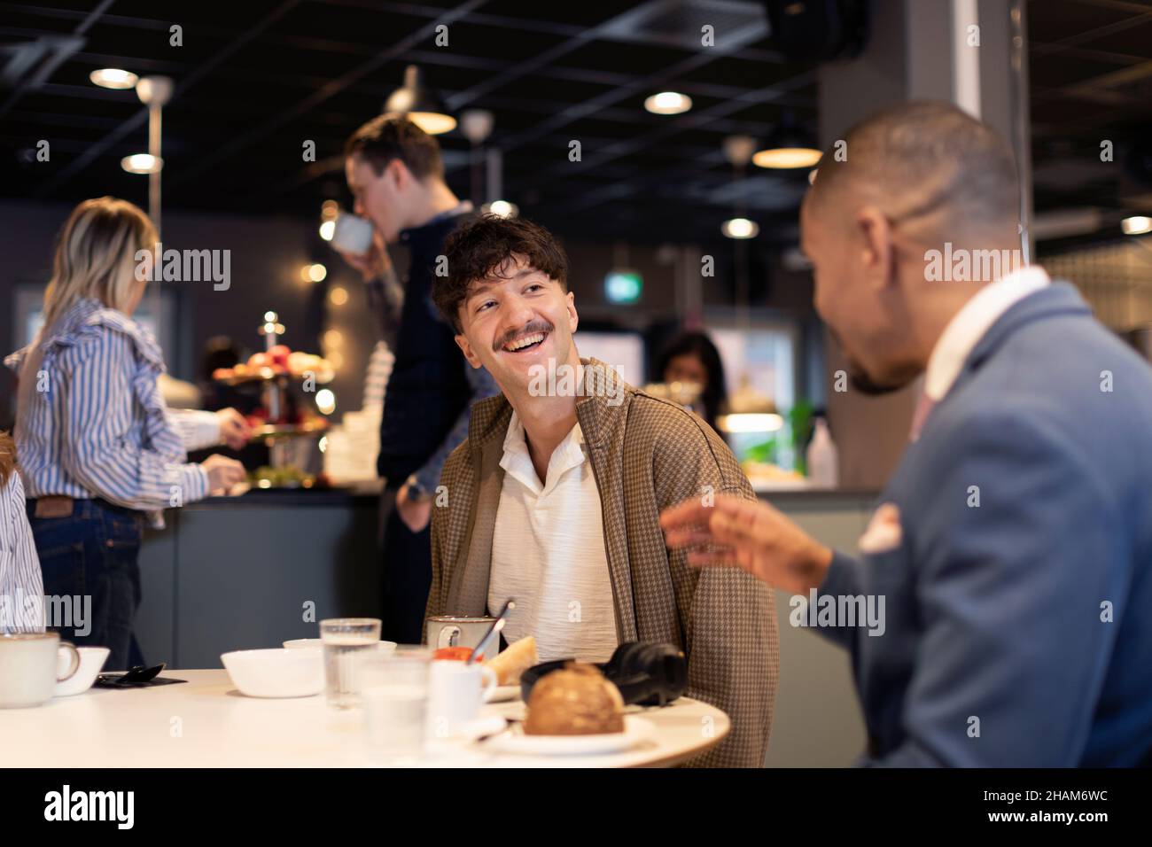 Coworkers talking during lunch Stock Photo - Alamy