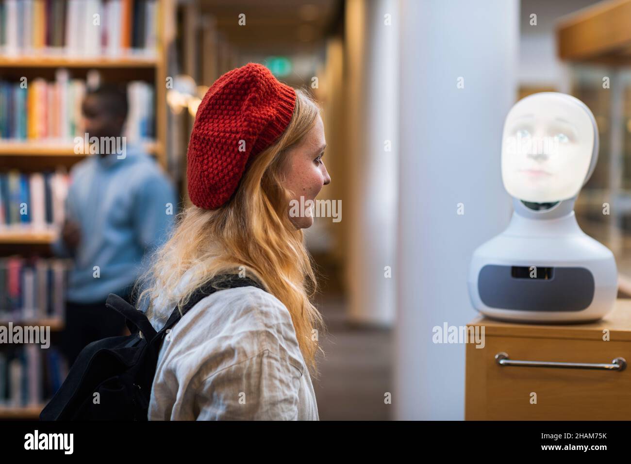 Student using voice assistant in library Stock Photo - Alamy