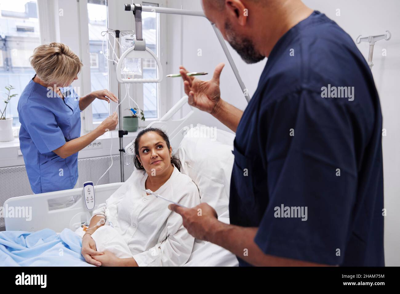 Female patient talking to nurse Stock Photo - Alamy