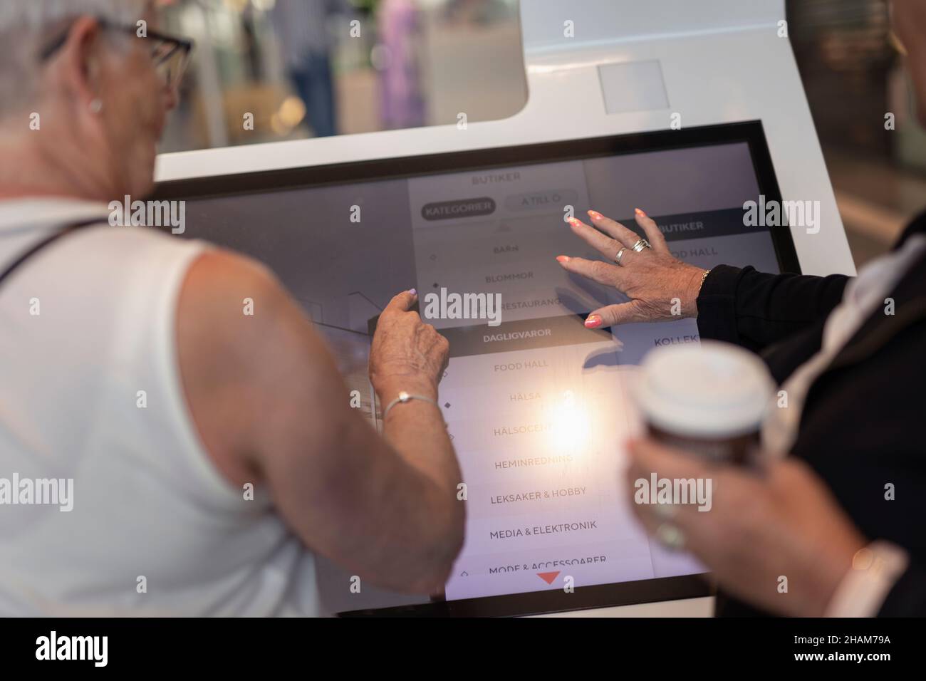 Women using touchscreen in shop Stock Photo - Alamy