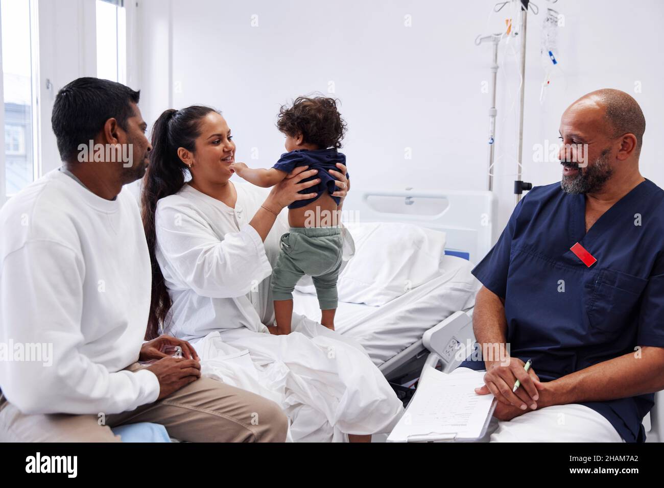 Parents with children in hospital room Stock Photo - Alamy