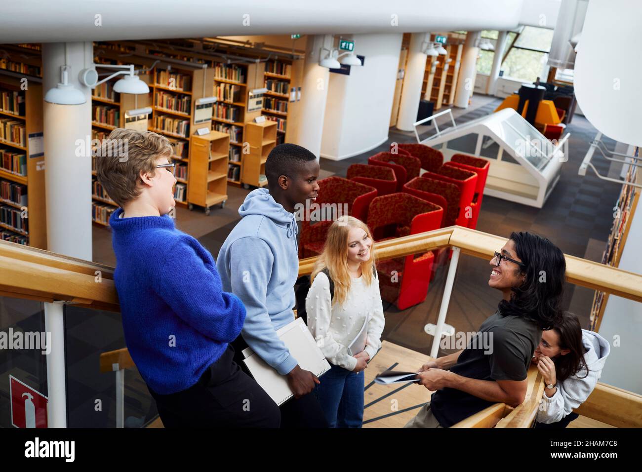 Group of students in library Stock Photo - Alamy
