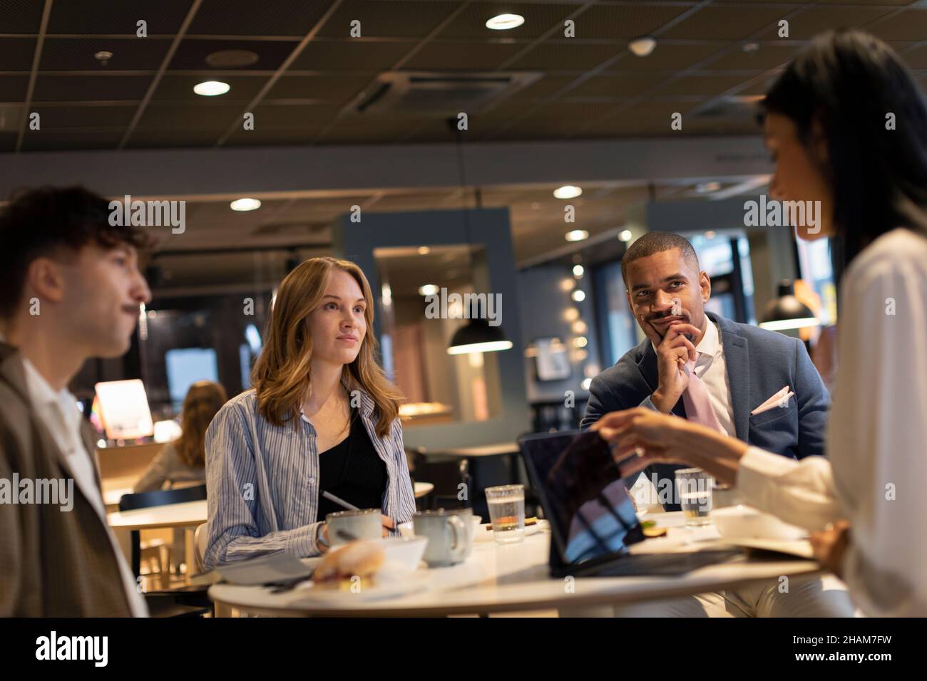 Coworkers talking during lunch Stock Photo - Alamy