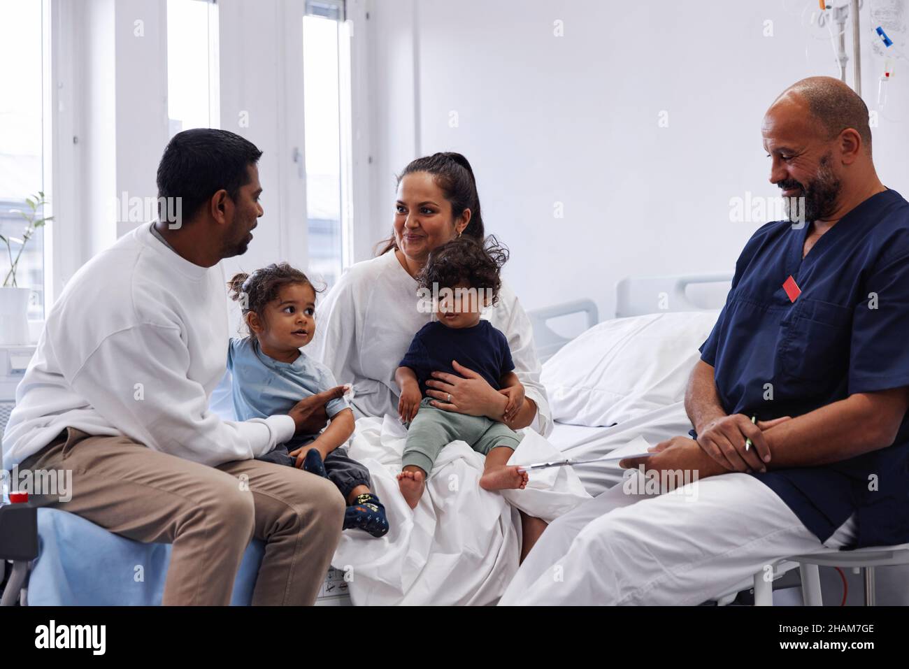 Parents with children in hospital room Stock Photo - Alamy