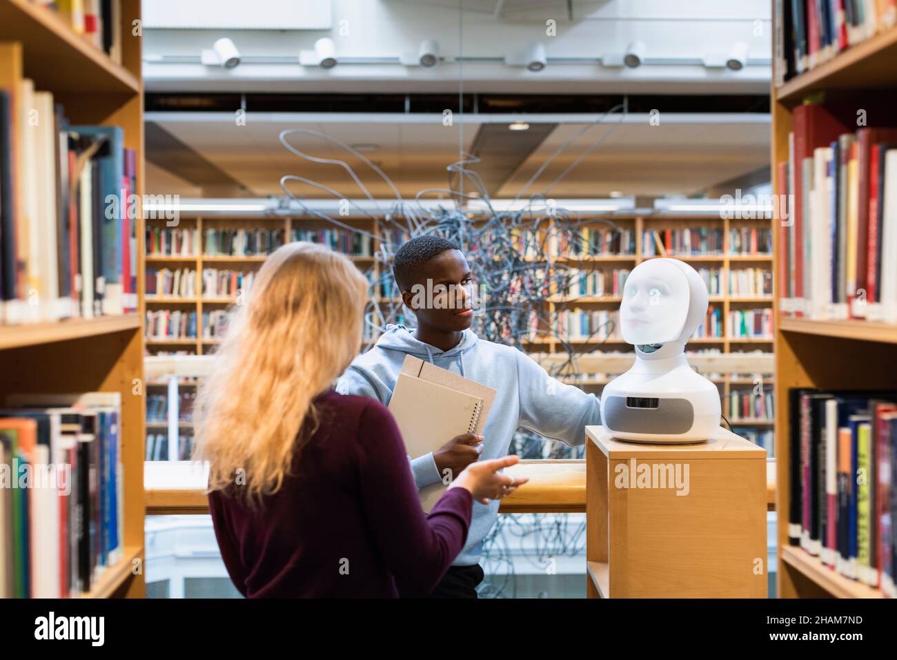 Students using voice assistant in library Stock Photo - Alamy