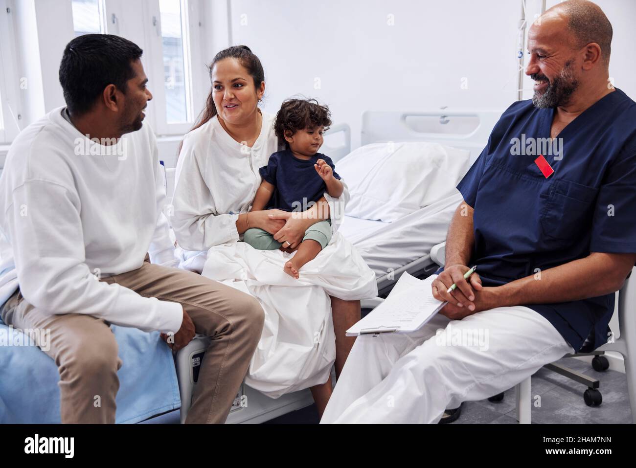 Parents with children in hospital room Stock Photo - Alamy