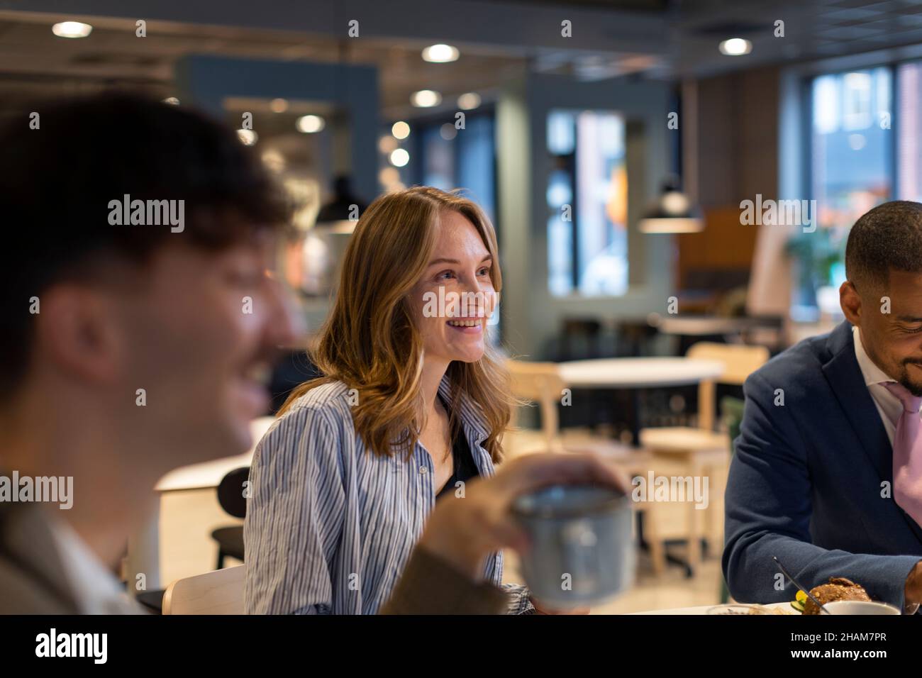 Coworkers talking during lunch Stock Photo - Alamy