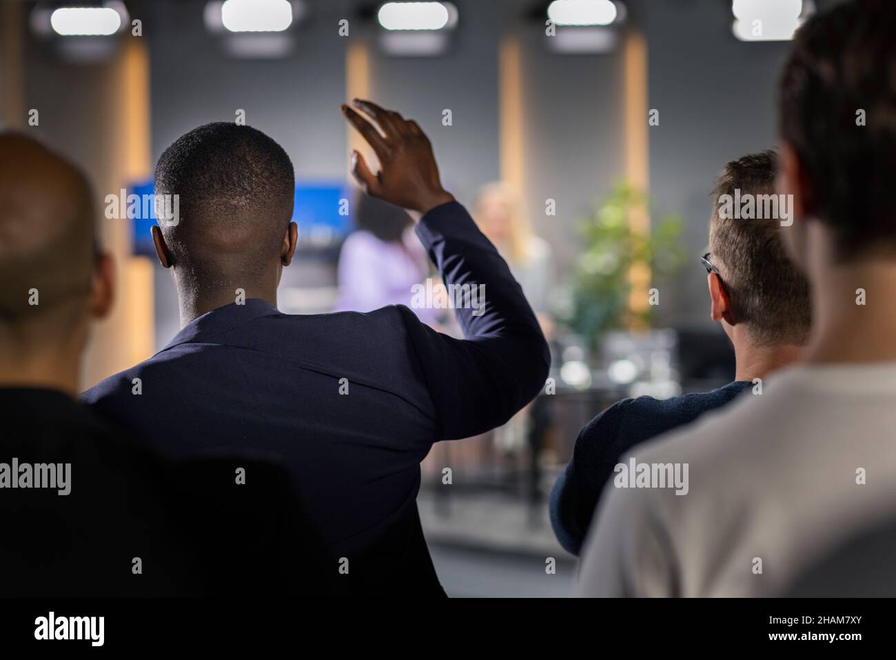 TV show audience member raising hand Stock Photo - Alamy