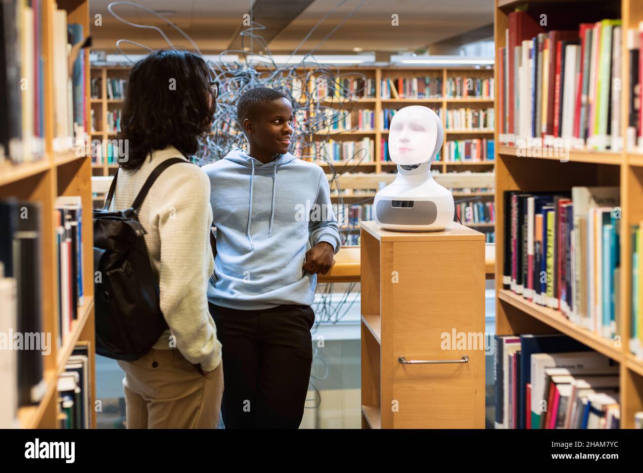 Students using voice assistant in library Stock Photo - Alamy